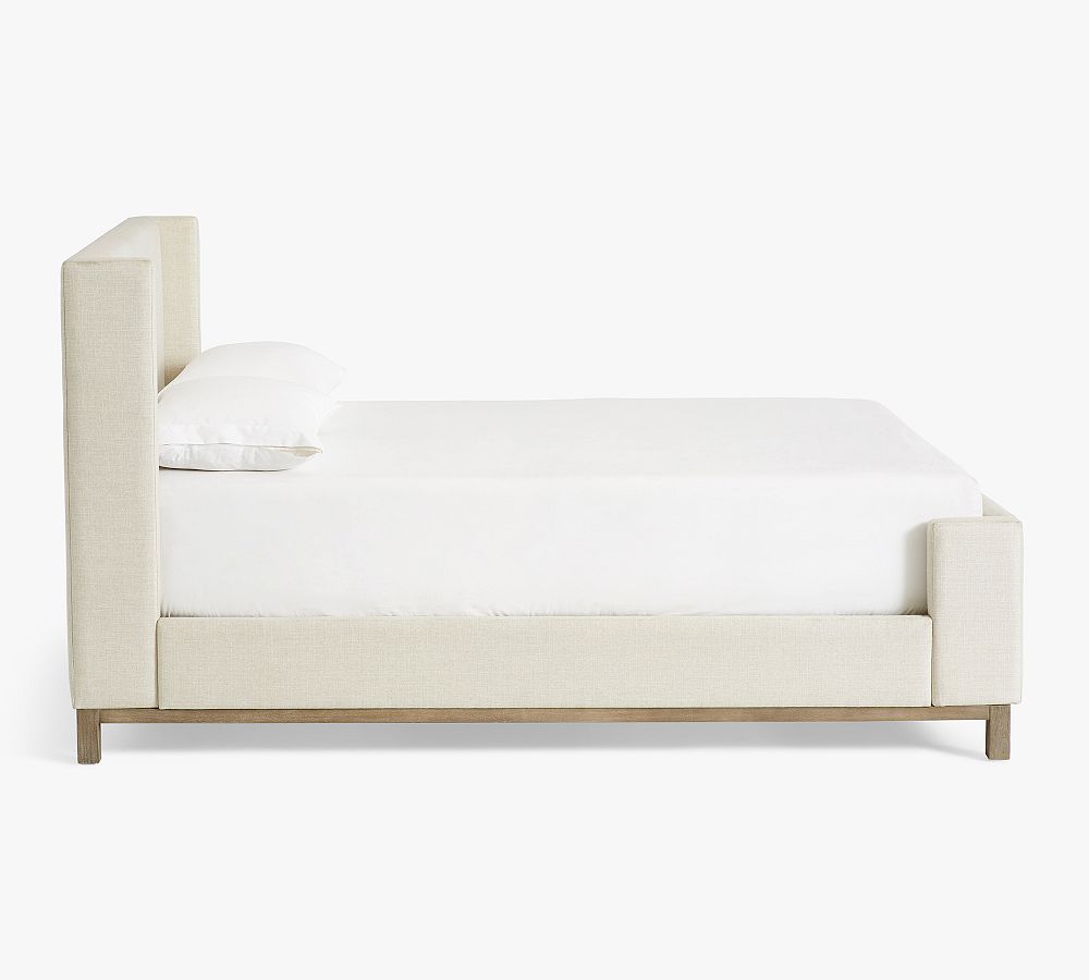 Jake Upholstered Platform Sleigh Bed with Wood Base | Pottery Barn