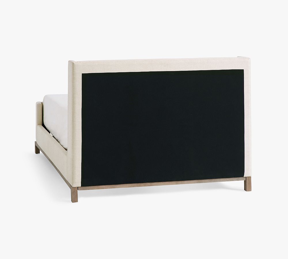 Jake Upholstered Platform Sleigh Bed with Wood Base | Pottery Barn